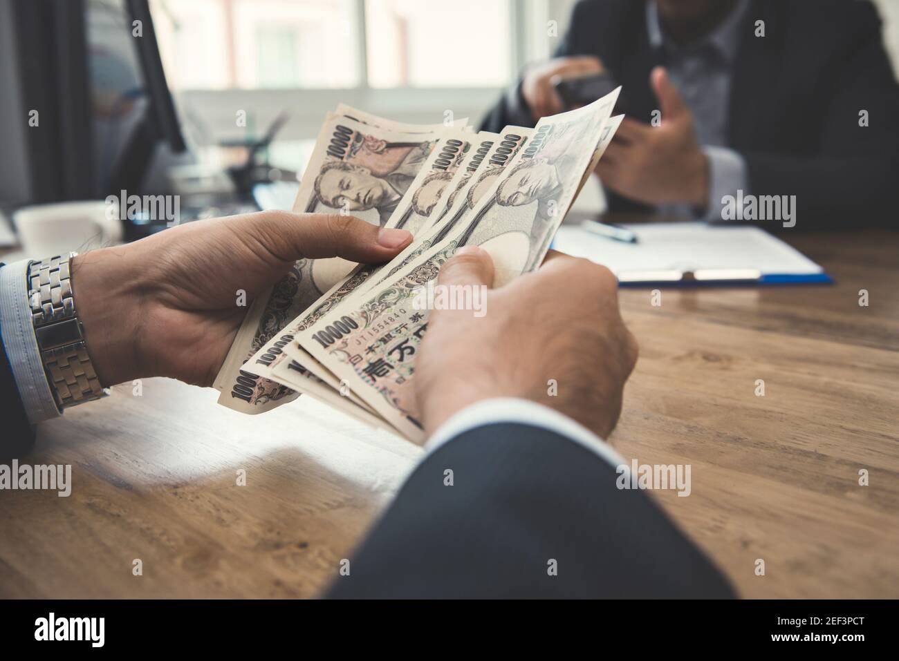 Businessman counting money, Japanese yen banknotes Stock Photo - Alamy