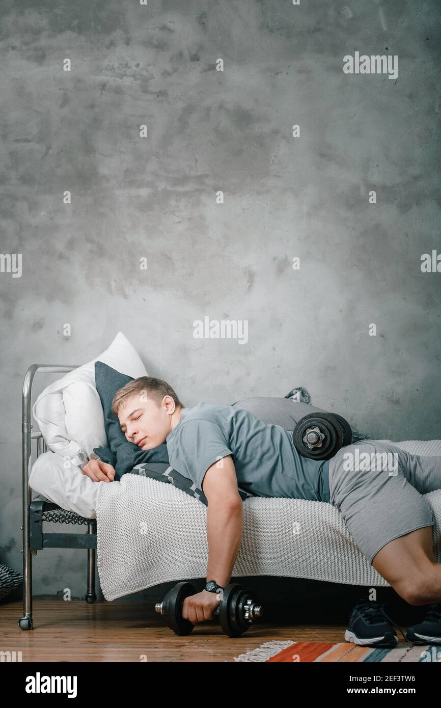 Close-up of a young man in a sports uniform is resting, sleeping on a ...