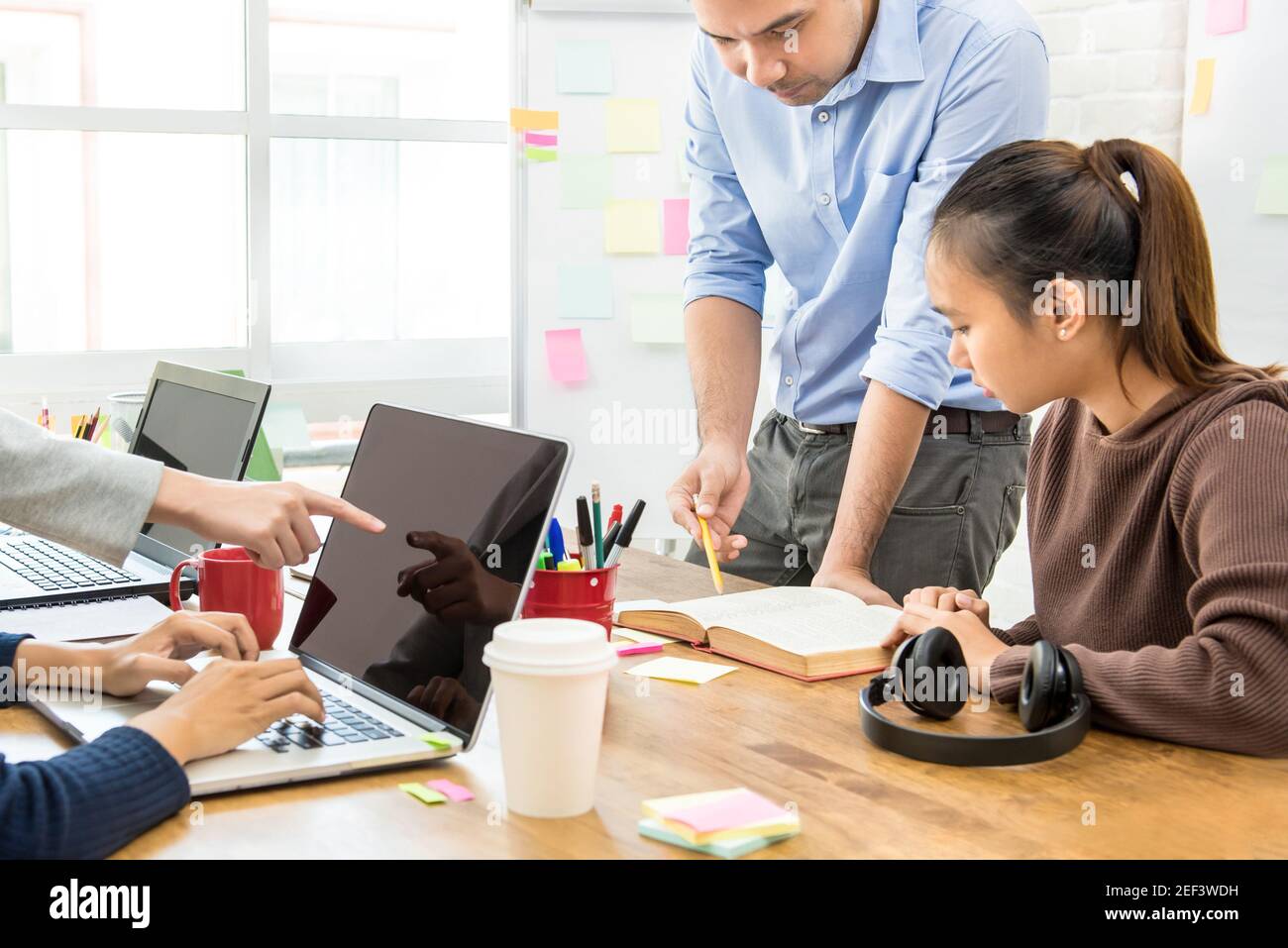 Group of university students sharing knowledge in co-working space ...