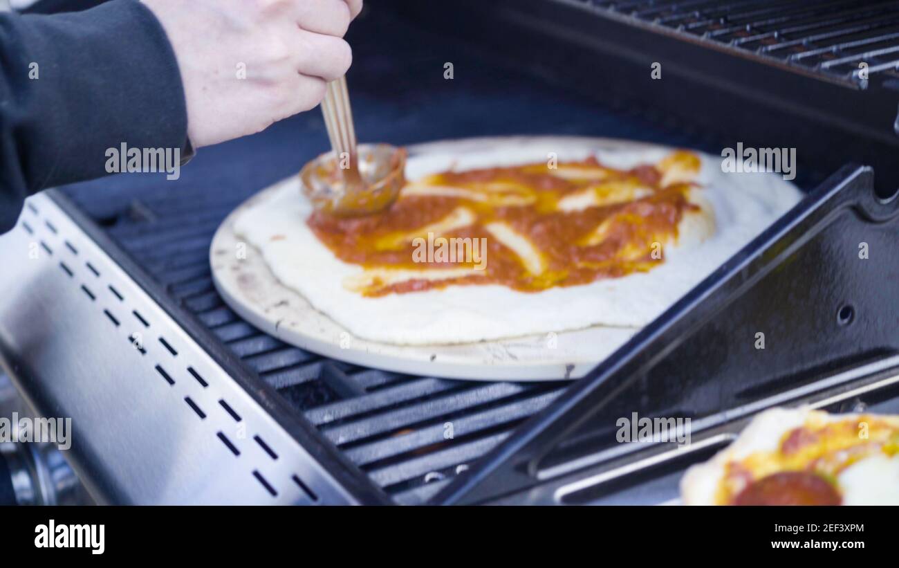 Cooking pizza on outdoor gas grill Stock Photo - Alamy