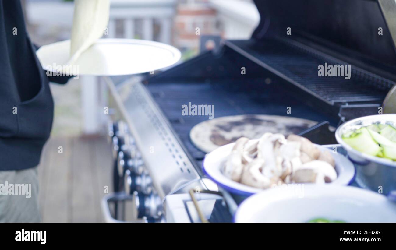 Cooking pizza on outdoor gas grill Stock Photo - Alamy