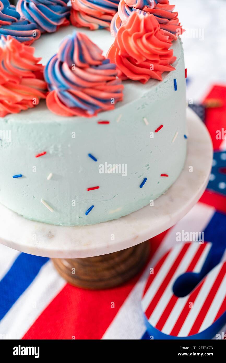 Red, white, and blue round vanilla cake with buttercream frosting for ...