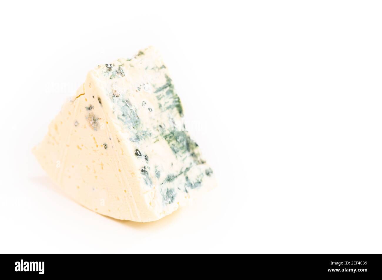 Large slice of blue cheese on a white background Stock Photo - Alamy