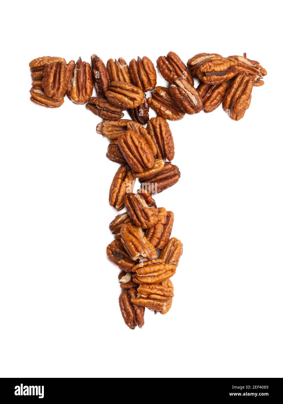 Letter T of the English alphabet from pecans on a white isolated ...