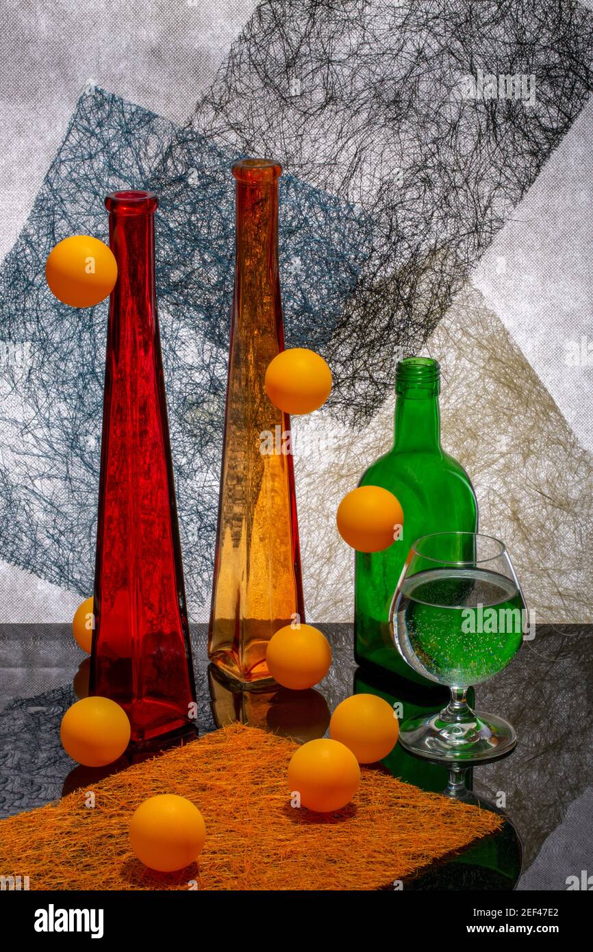 Still life with glassware and orange balls Stock Photo - Alamy