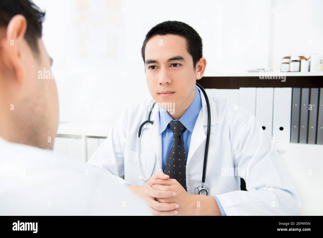 Doctor listening to his patient with care and understanding Stock Photo ...