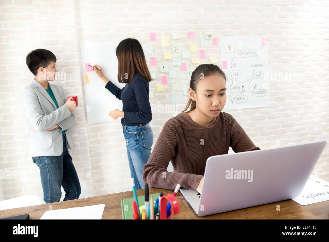 Group of oversea students doing project in classroom Stock Photo - Alamy