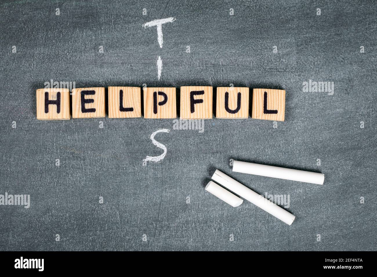 Helpful Tips concept. Wooden alphabet letters on a gray chalk board ...