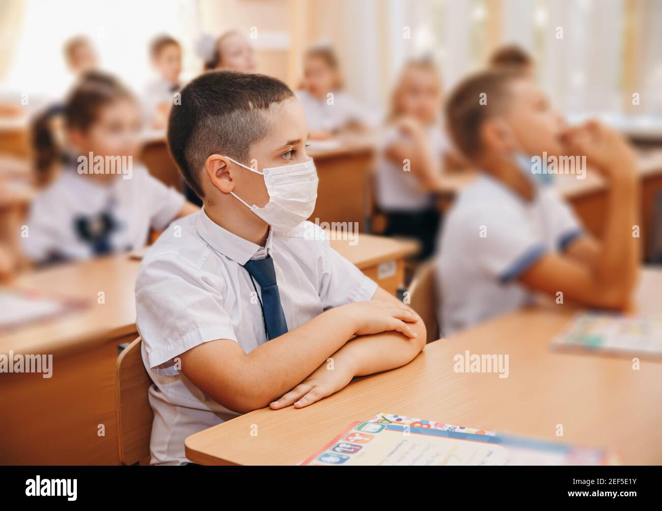 Happy caucasian boy student wearing face mask in the classroom Stock ...