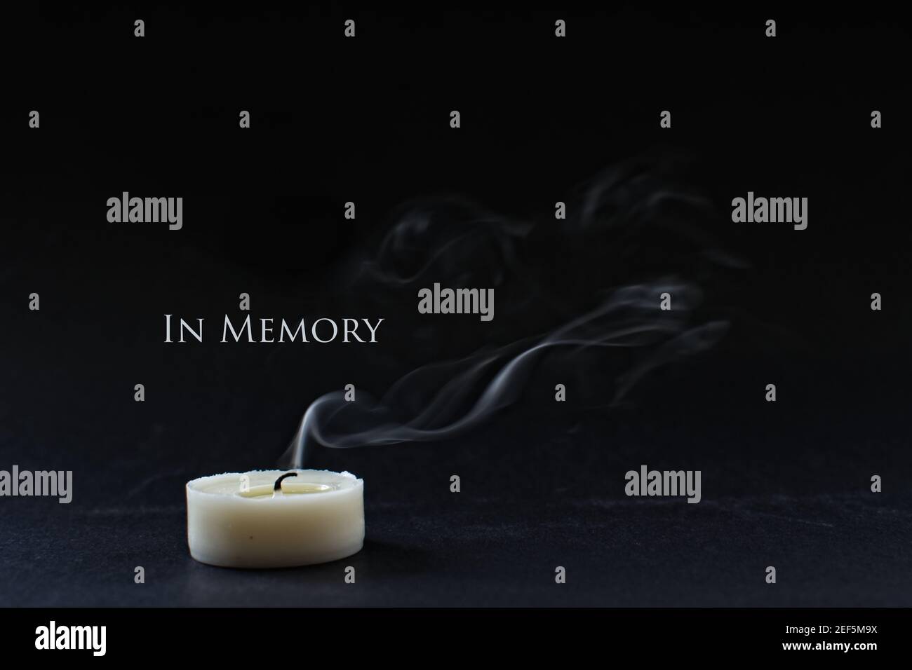 In memory of a loved one. Extinguished candle with smoke Stock Photo ...