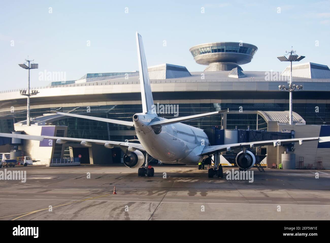 Jet passenger airplane with a ramp parked at the airport against the ...