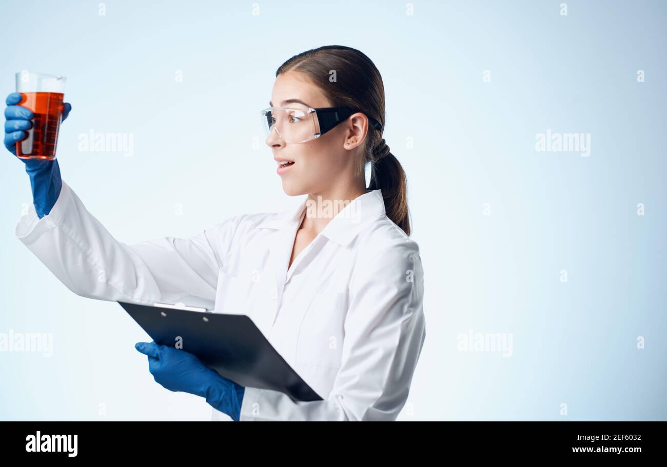 woman with liquid in a flask laboratory research chemical element ...