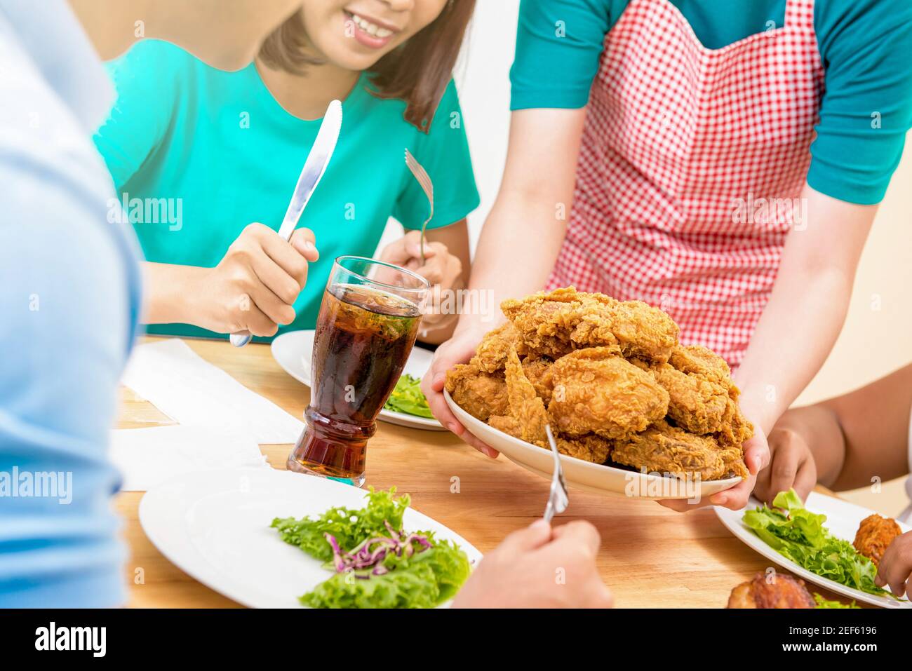 Group of young people at dining table ready to eat fried chicken being ...