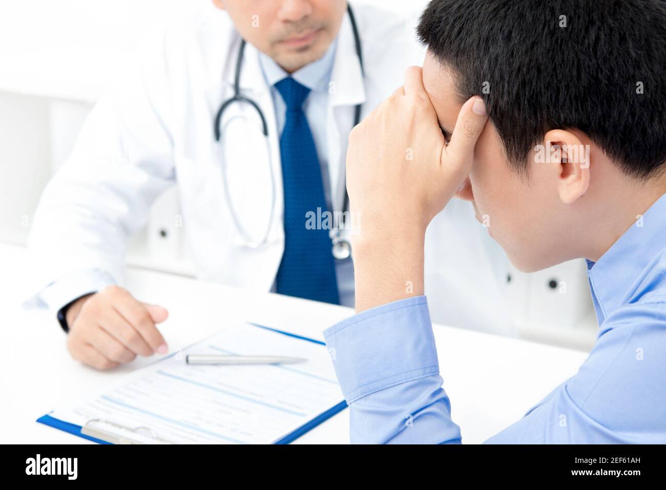 Young stressed male patient consulting with doctor Stock Photo - Alamy
