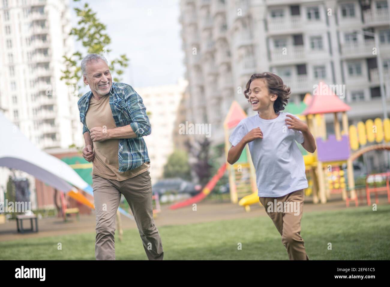 Dad and son running and looking enjoyed Stock Photo - Alamy