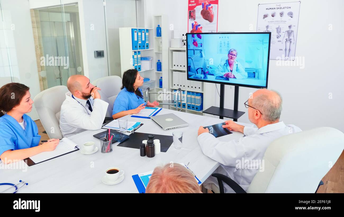 Team of medical staff during video conference with doctor in hospital ...