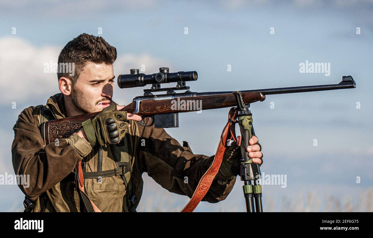Hunter with hunting gun and hunting form to hunt. Hunter is aiming ...