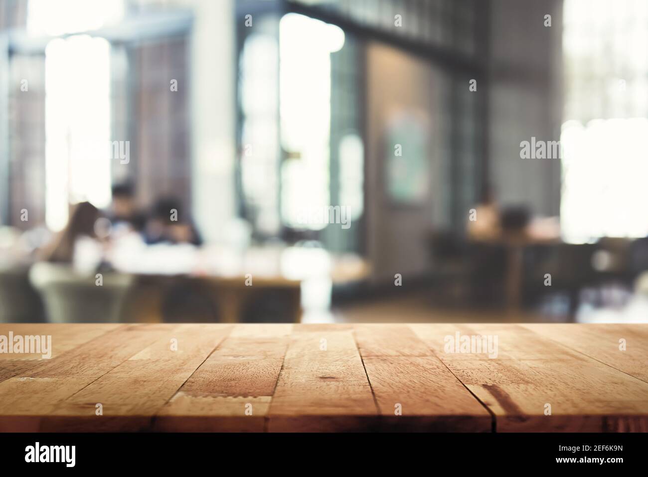 Wood table top on blur restaurant (cafe) interior background - can be ...