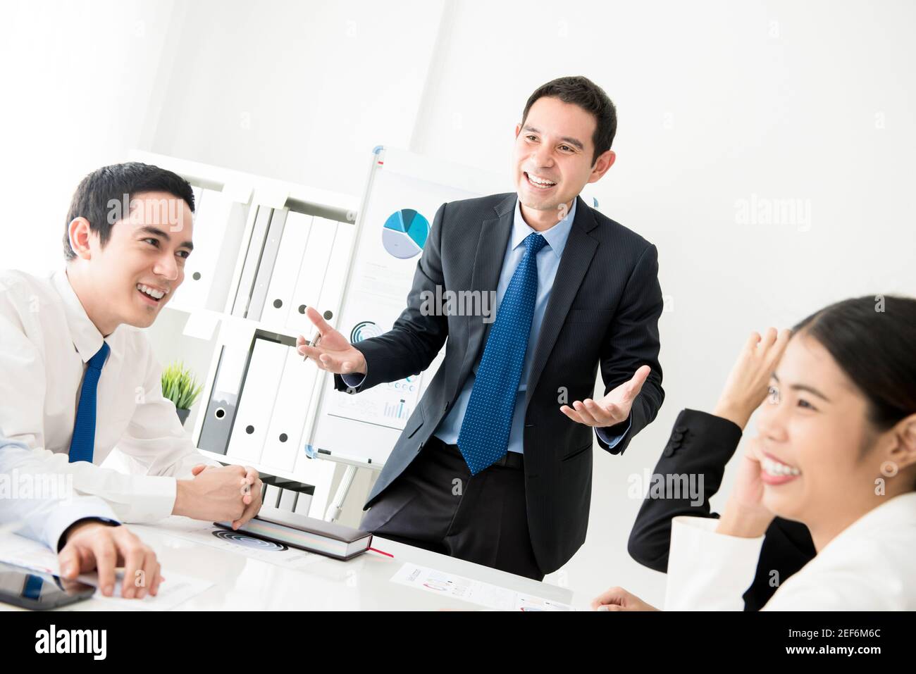 Happy cheerful businessman as a meeting leader talking to his ...