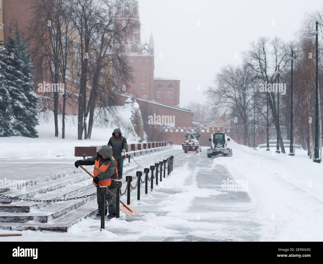 Moscow. Russia. February 12, 2021. Utility workers use shovels to clear ...