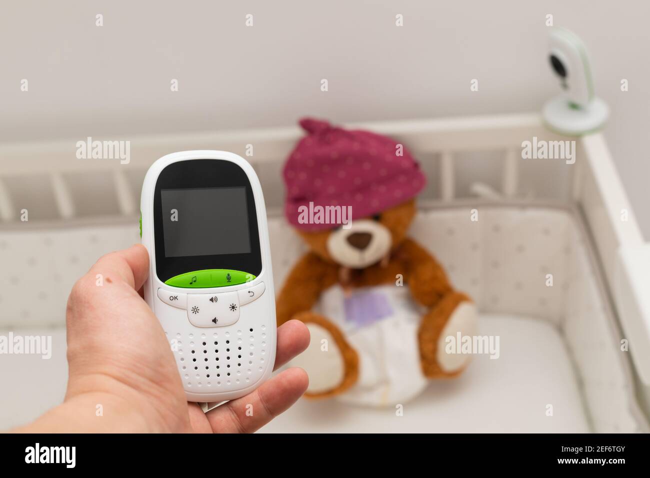 Picture of a baby monitor, camera and a teddy bear in child room Stock ...