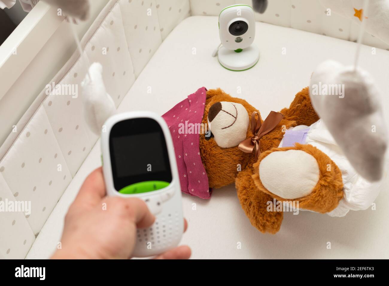 Picture of a baby monitor, camera and a teddy bear in child room Stock ...