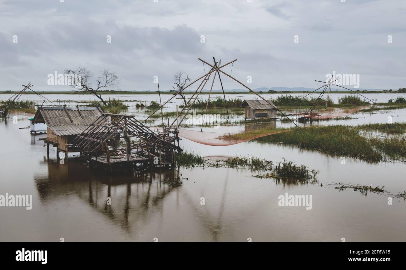 Fisherman cottage in swamp and square dip fish trap with cloudy raining ...