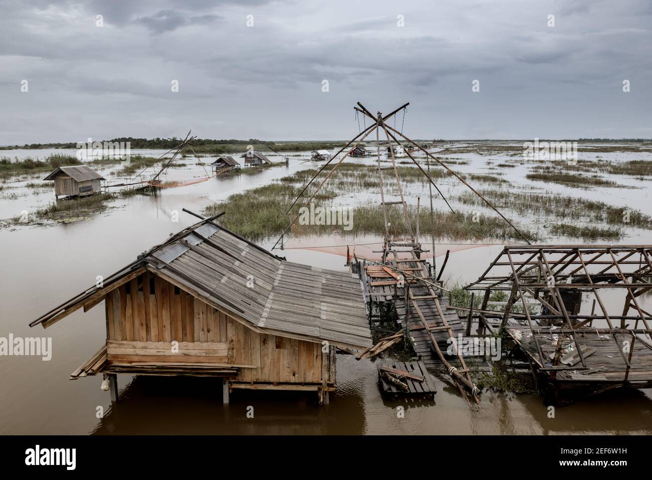 Fisherman cottage in swamp and square dip fish trap with cloudy raining ...