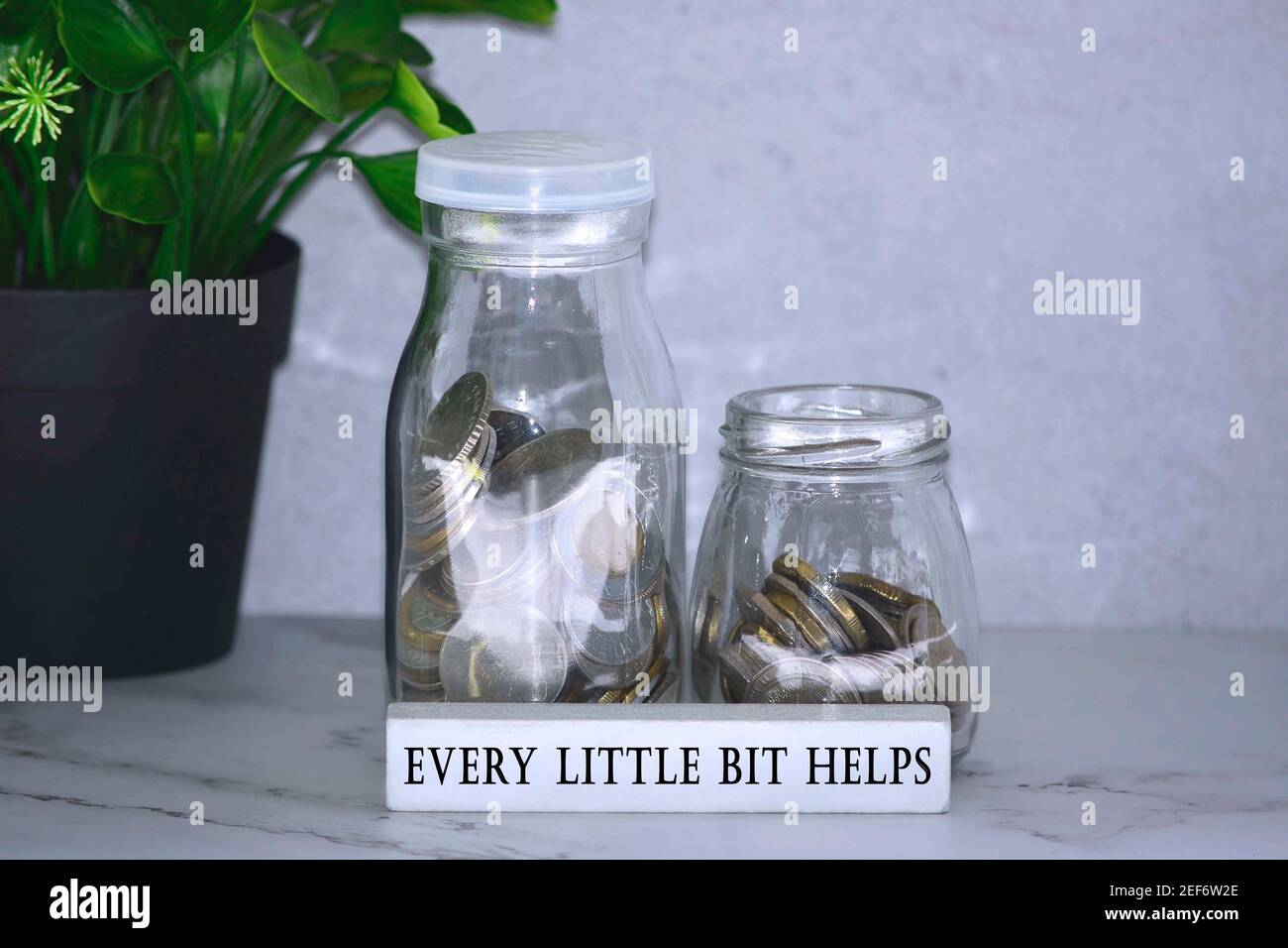 Text on wood block with Australian and European coins on table surface ...