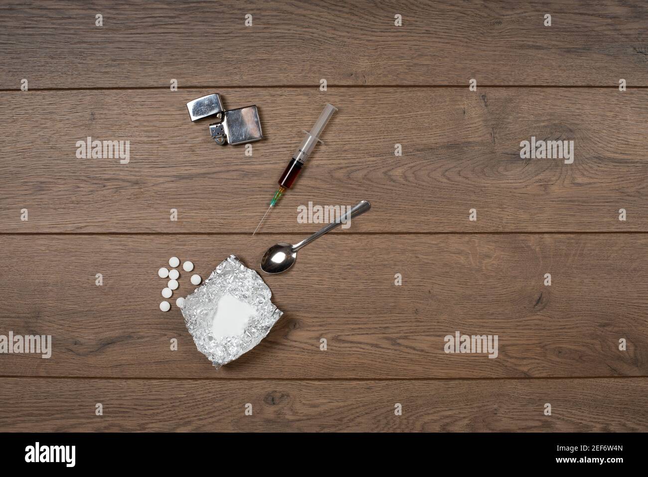 Drug syringes, heroin, spoon on a wooden floor Stock Photo - Alamy