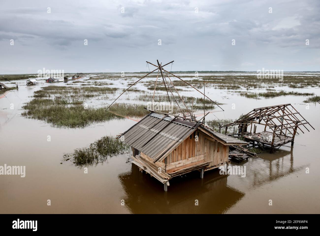 Fisherman cottage in swamp and square dip fish trap with cloudy raining ...