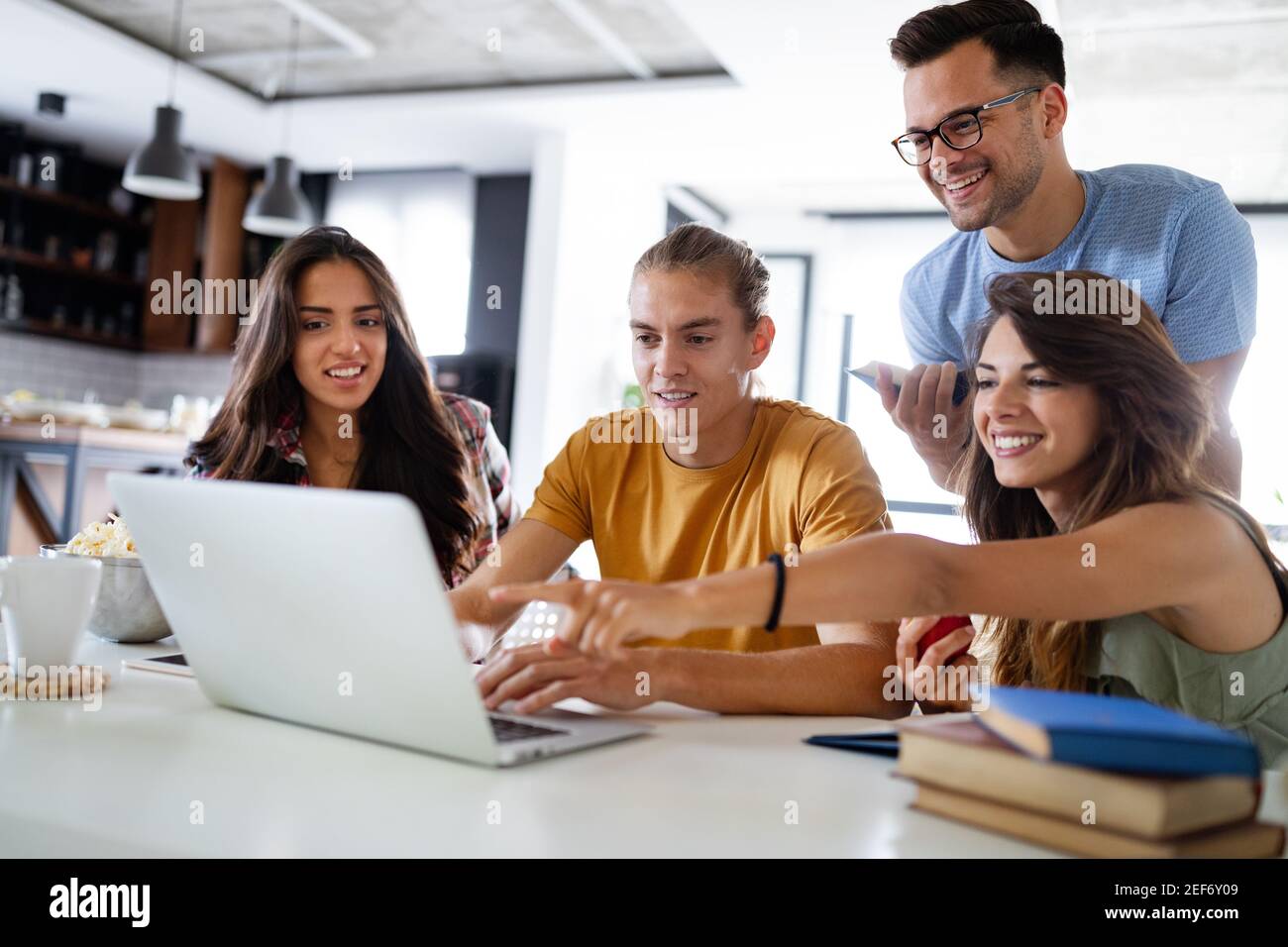 Happy group of students studying and working together in a college ...