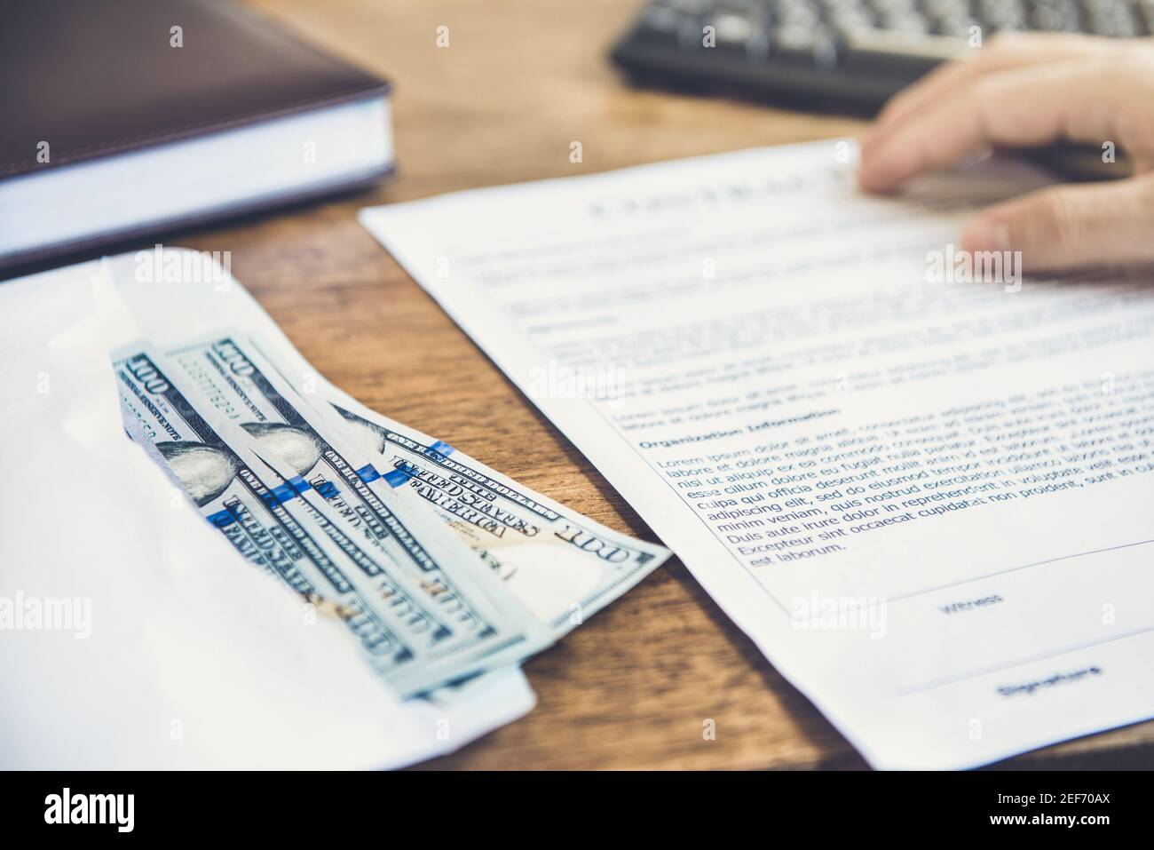 Money (US dollar bills) on the table beside contract paper - loan ...