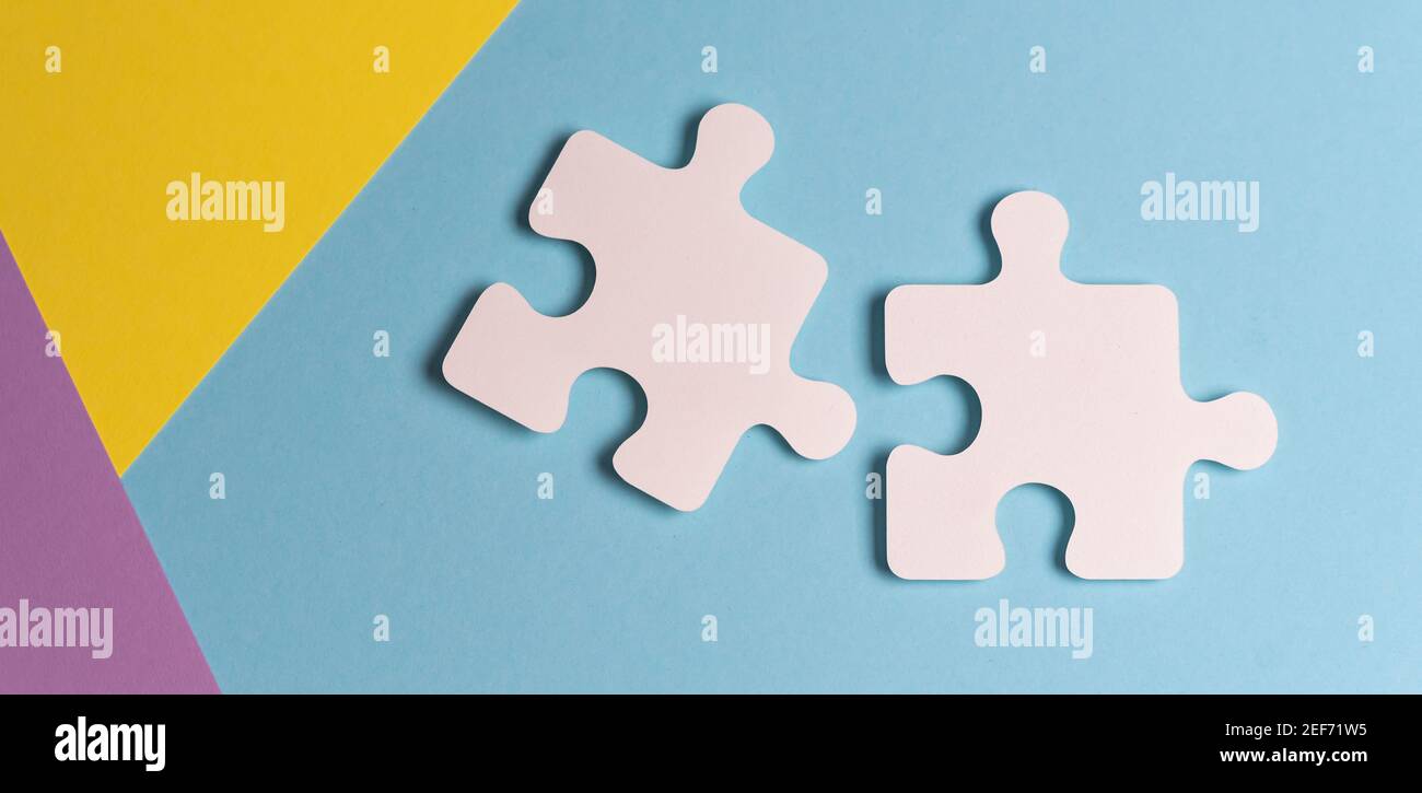 Concept of teamwork with paper puzzle pieces on pastel colors ...