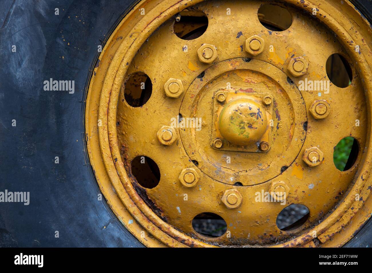 Old yellow wheel with black tire, rustic heavy machine detail photo ...