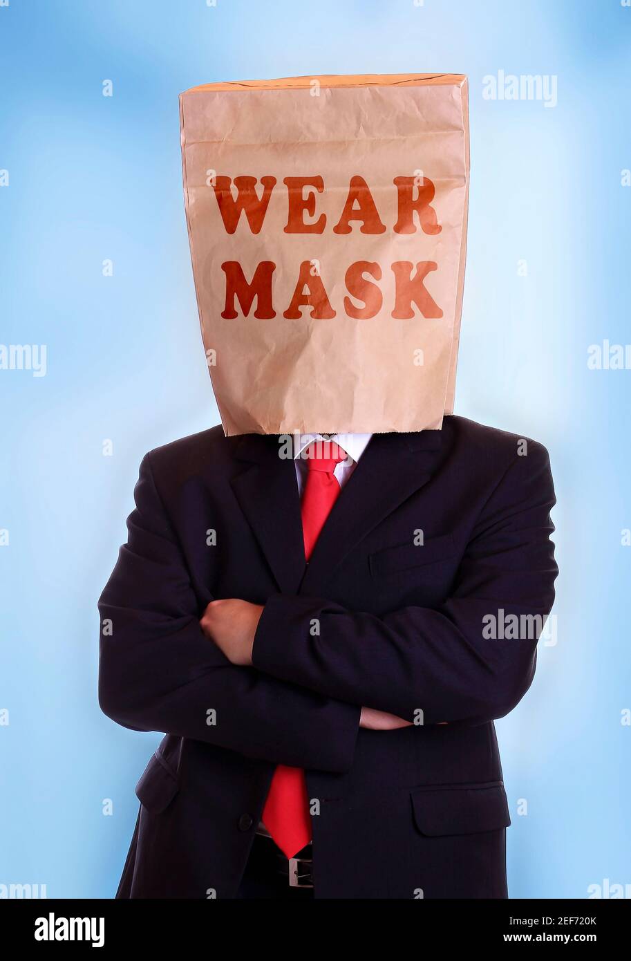 Man with a paper bag on head wear mask text on it Stock Photo - Alamy
