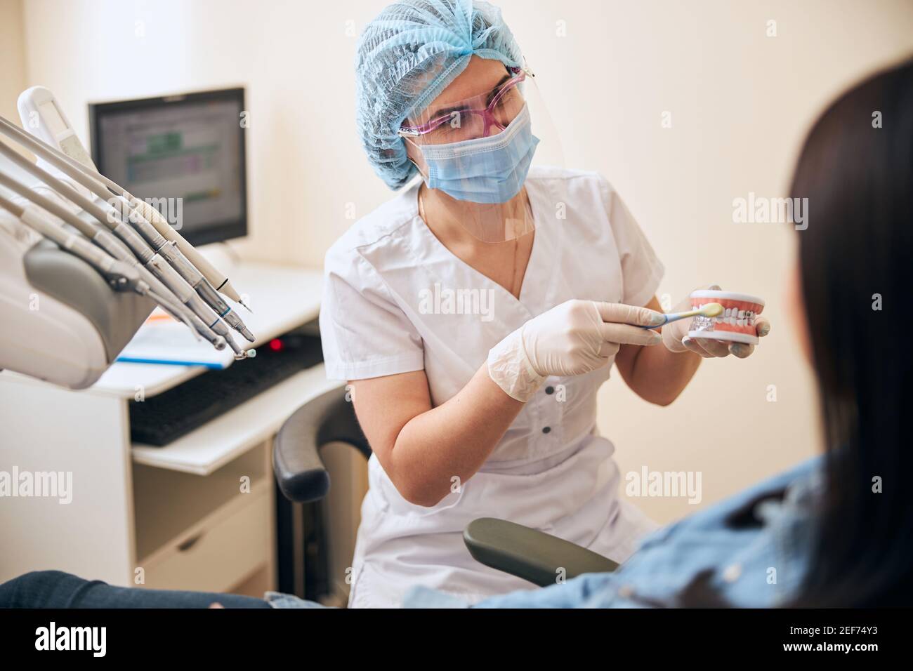 Professional dentist showing the way of teeth care Stock Photo - Alamy