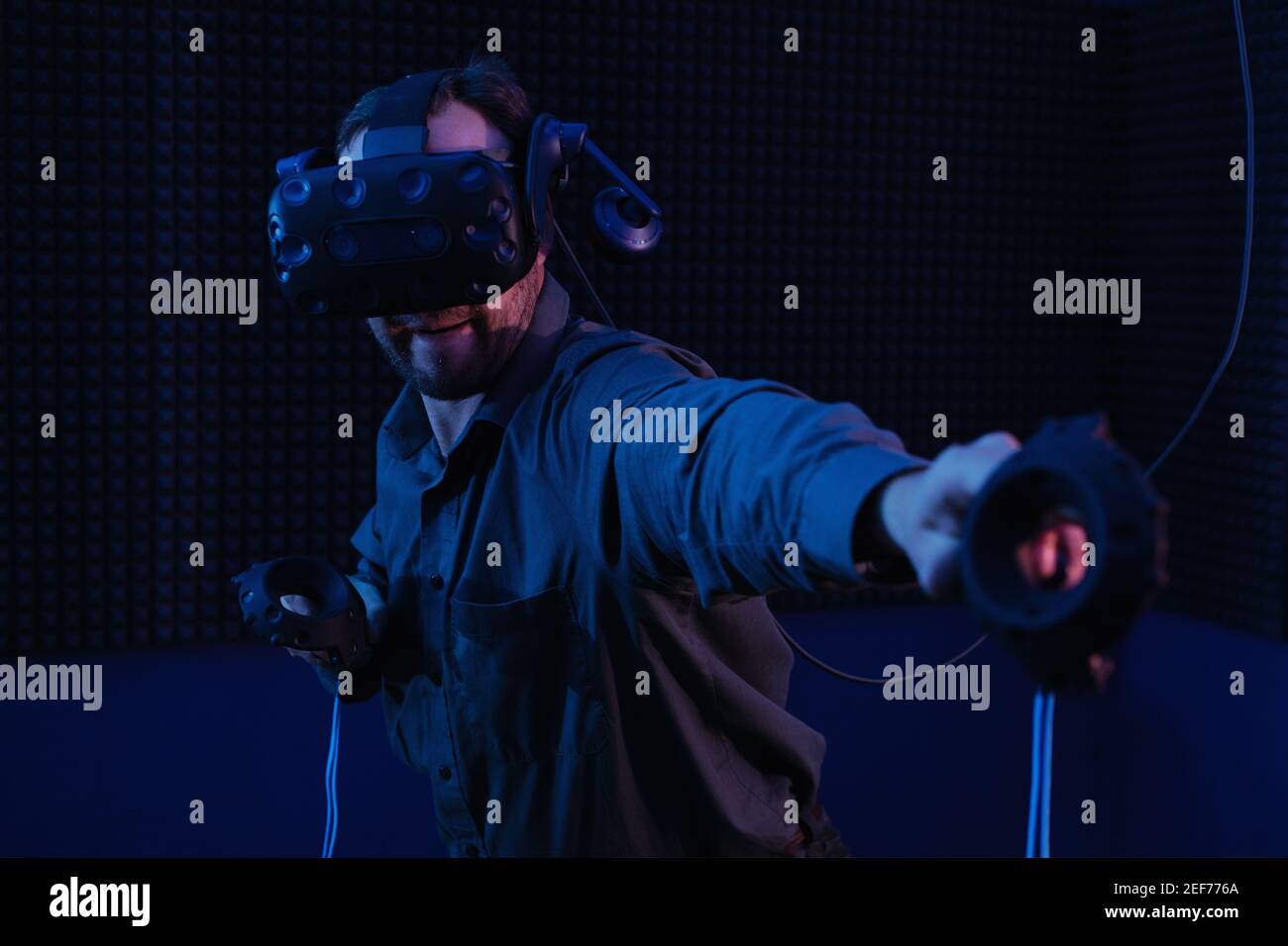 Man enjoying VR technology, wearing virtual reality headset and playing ...