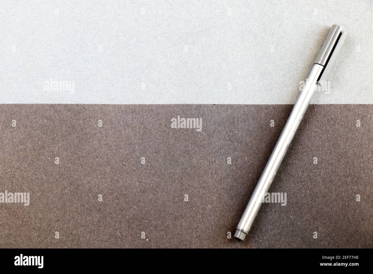 Grey pen on the black and gray papers background and texture, gray ...