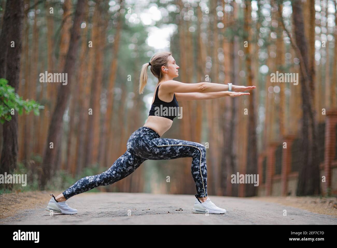 Sporty young woman training in summer forest. Fit and strong female ...