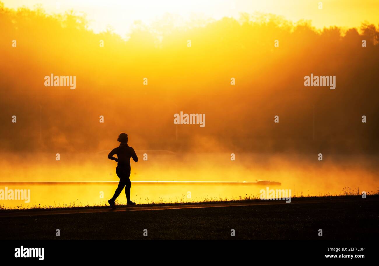 Silhouette of running man at sunrise Stock Photo - Alamy