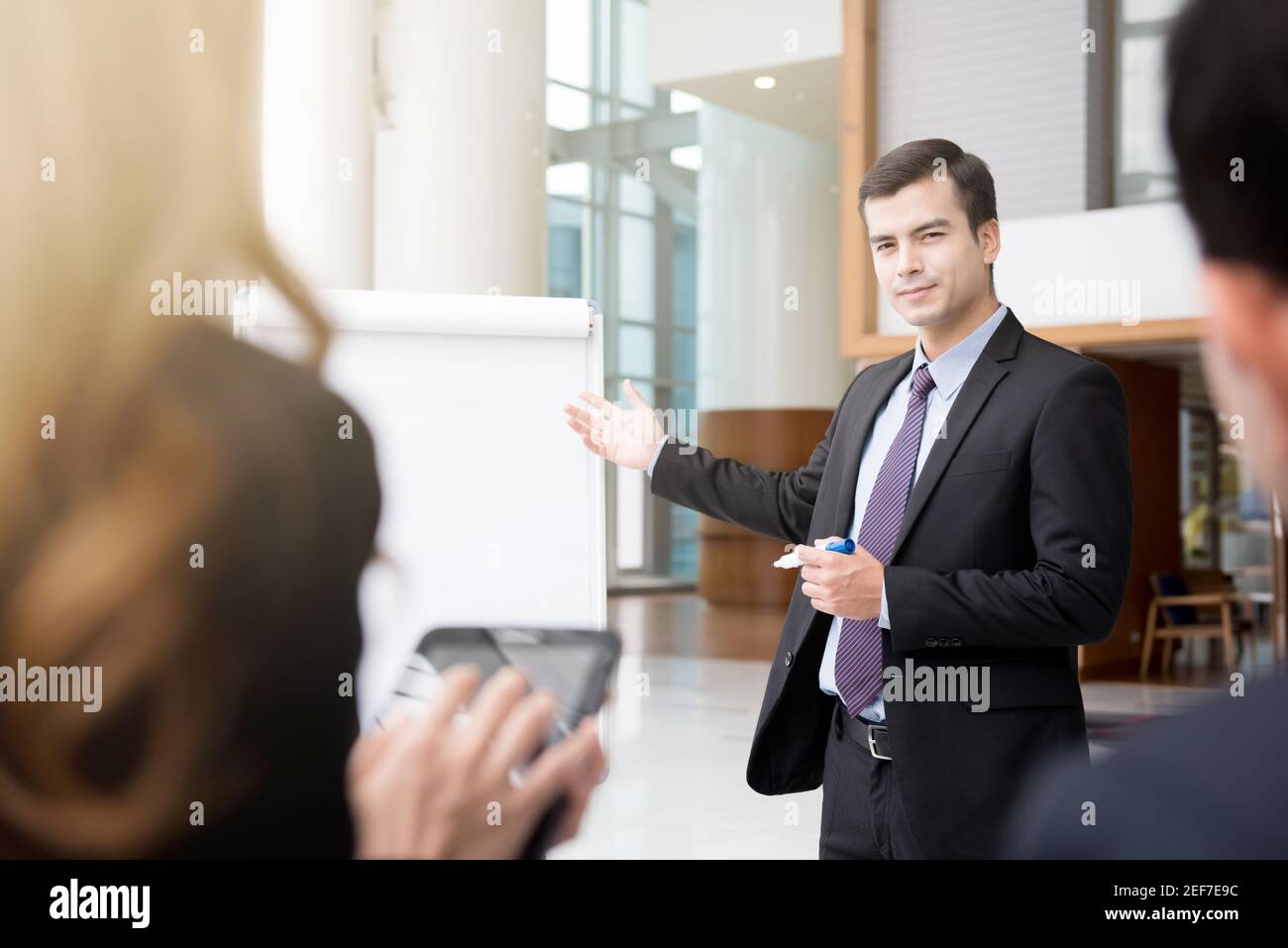 Young businessman as a meeting leader presenting his work Stock Photo ...