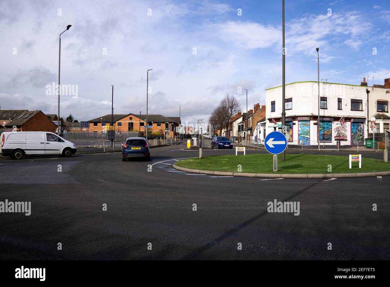 Urban road traffic island junction Stock Photo - Alamy