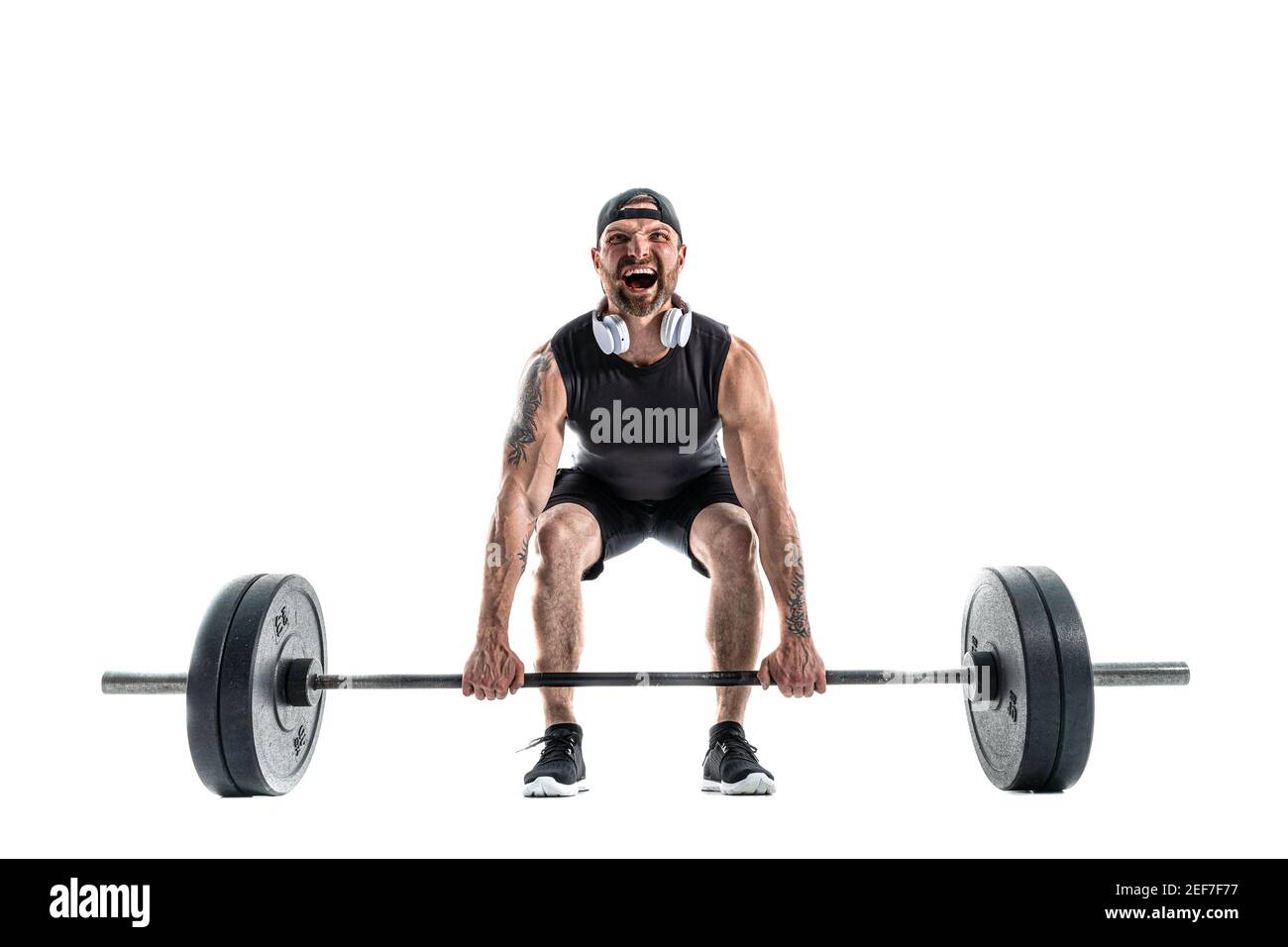 Aggressive bearded strong muscular Man in sportswear and headphones ...