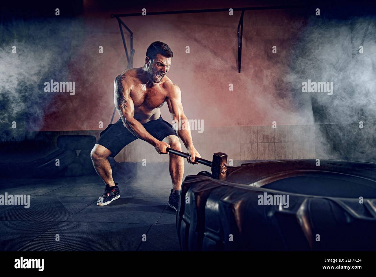 Sports training for endurance, man hits hammer. Concept workout Stock ...