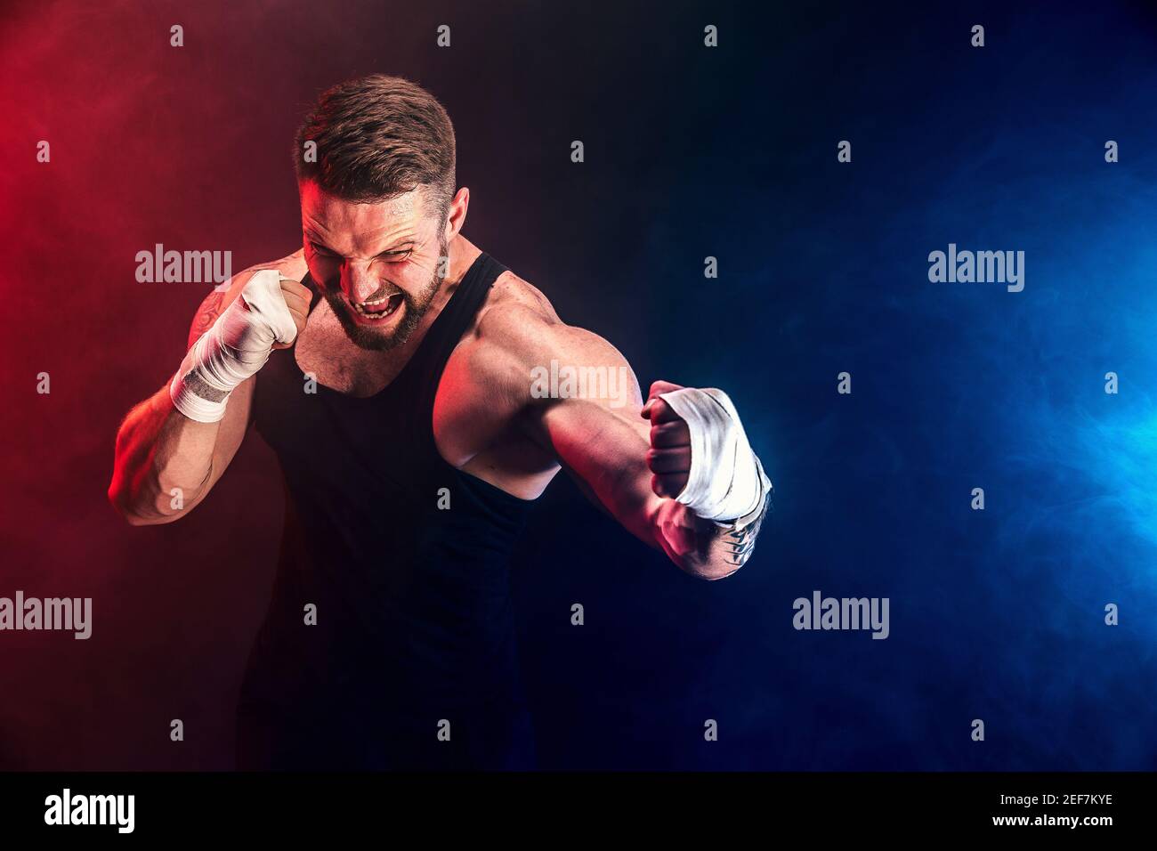 Bearded tattooed portsman muay thai boxer in black undershirt and ...