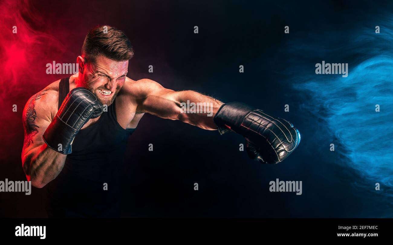 Bearded tattooed sportsman muay thai boxer in black undershirt and ...
