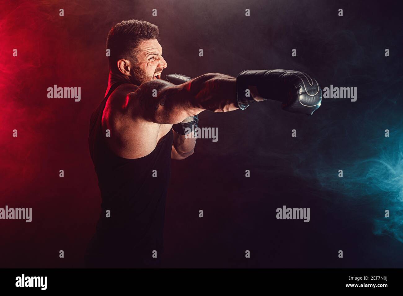 Bearded tattooed sportsman muay thai boxer in black undershirt and ...