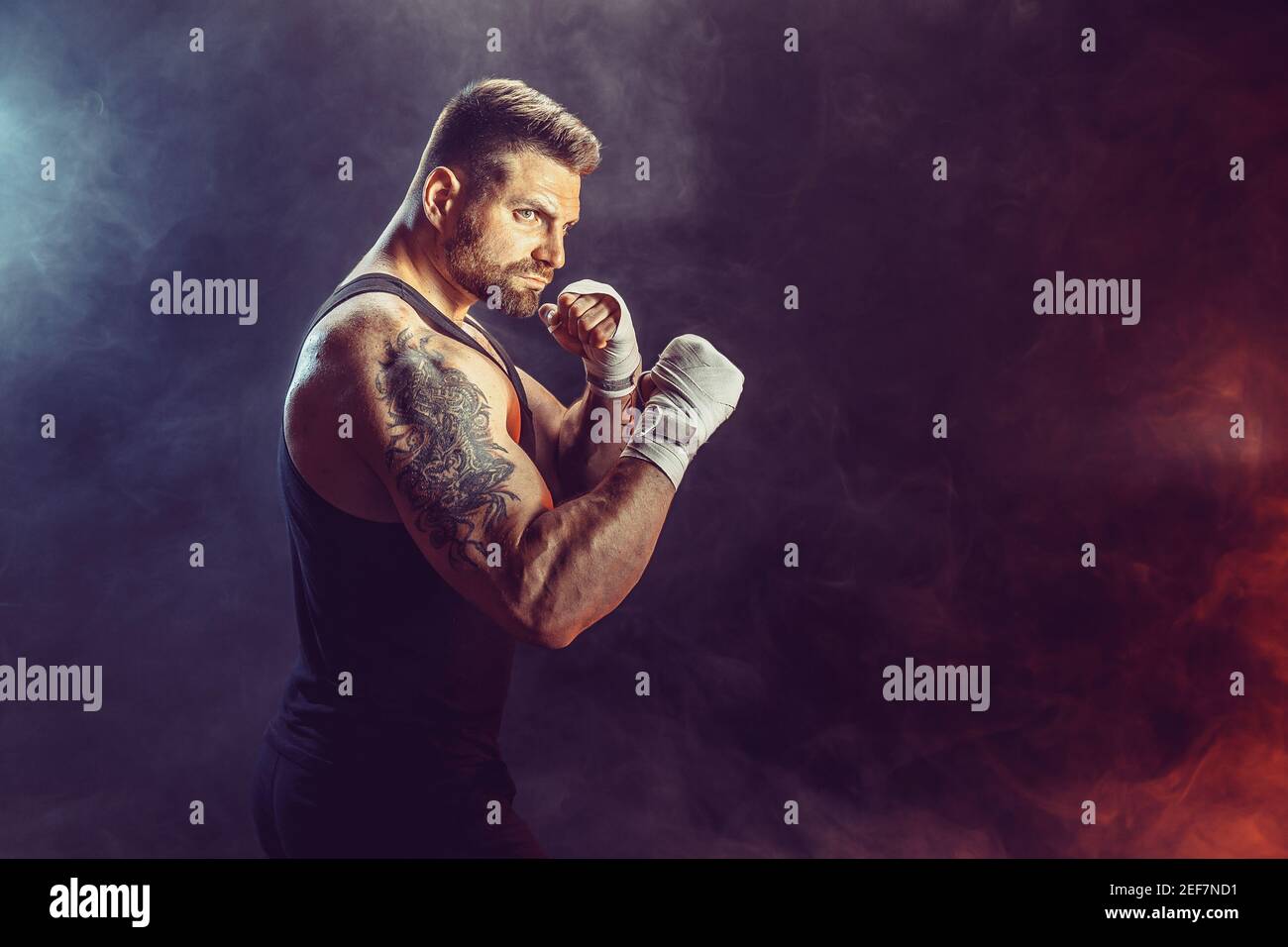 Sportsman boxer fighting on black background with shadow. Copy Space ...