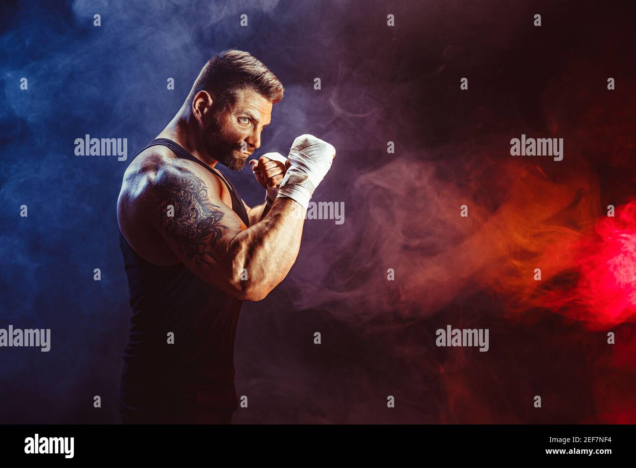 Sportsman boxer fighting on black background with shadow. Copy Space ...